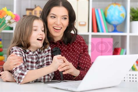 Mother And Daughter Singing Karaoke Stock Image Colourbox