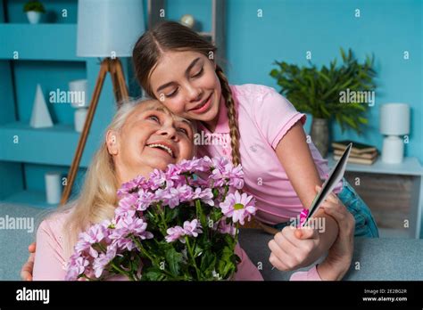 Cinematic Portrait Image Of Grandmother And Grandaughter Sitting On