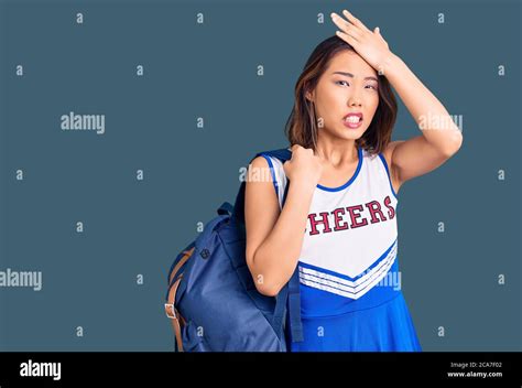 Young Beautiful Chinese Girl Wearing Cheerleader Uniform Holding