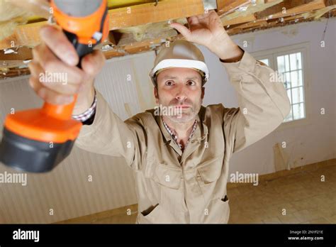 Male Builder Using Cordless Drill Overhead Stock Photo Alamy