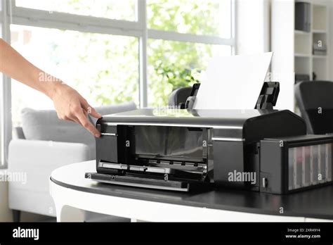 Female Hands Putting Paper Sheet In Modern Printer On Table In Stylish Office Stock Photo Alamy