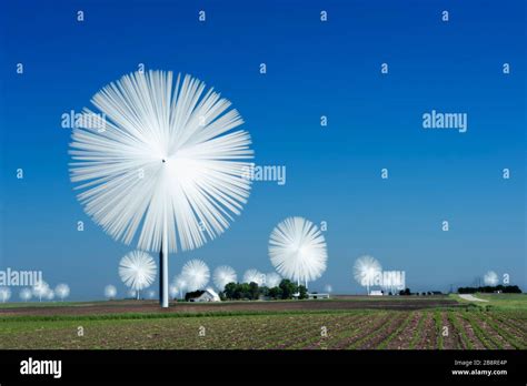 Farming Wind A Stacked Image Of Wind Turbines Towering Over A Farm In