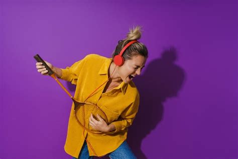 Premium Photo Cheerful Girl Is Jamming Out In Her Yellow Shirt While