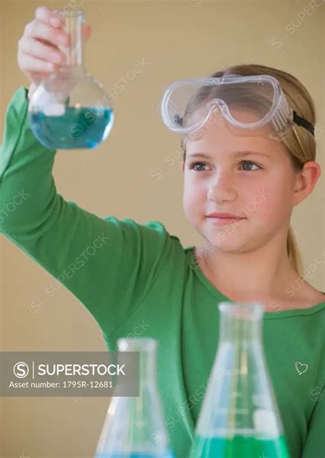 Girl In Science Class Looking At Beaker Superstock
