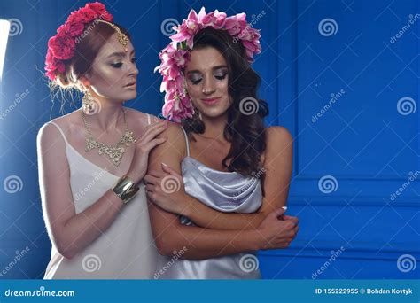 Portrait Of The Two Gorgeous Ladies With Wild Flowers Elegance