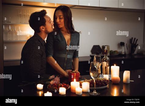 Beautiful Passionate Couple Having A Romantic Candlelight Dinner At