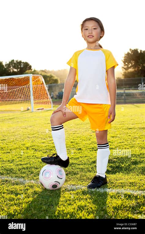 A Young Girl Posing With Her Soccer Ball On A Soccer Field In Los
