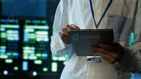 Certified Technician Strolling Through Server Rows Providing Processing Resources For Different