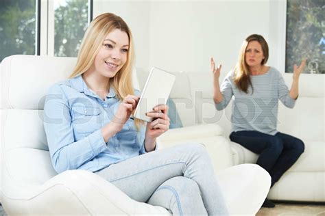 Mother Arguing With Daughter Over Use Of Mobile Phone Stock Image