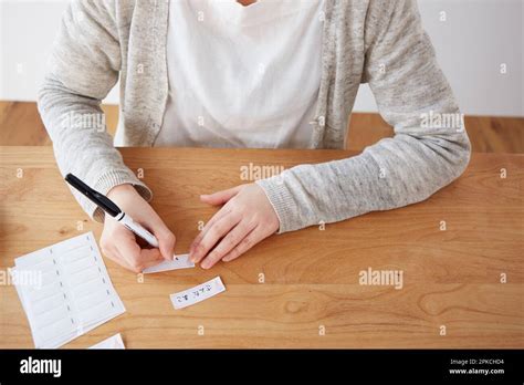 A Woman Writing Her Name On A Name Tag Stock Photo Alamy