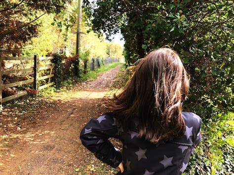 Premium Photo Rear View Of Girl Standing In Park