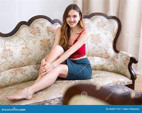 Smiling Woman Relaxing On Luxurious Couch In Livingroom Room Stock