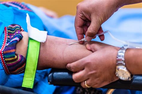 Premium Photo Close Up Of Doctor Injecting Syringe To Patient
