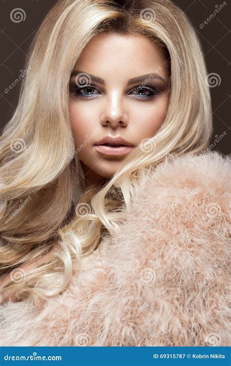 Beautiful Glamor Blondie Woman In Fur Coat Evening Makeup And Curls