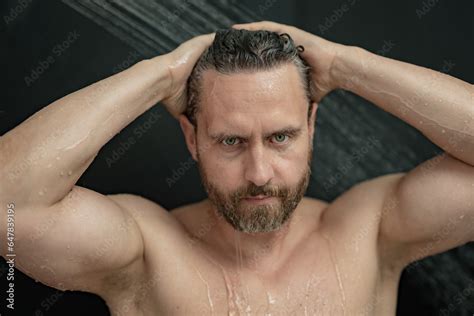 Millennial Man Washing Hair In Bath Guy Bathing Shower Head In Bathtub