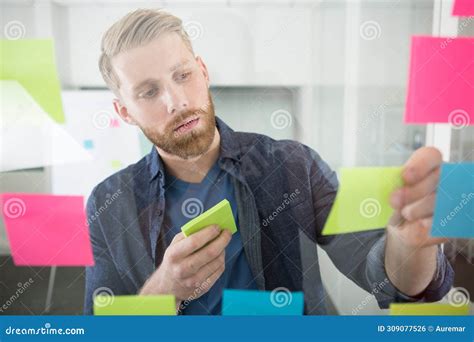 Man Analyzing Data Plans And Project With Note On Board Stock Photo Image Of Board Business