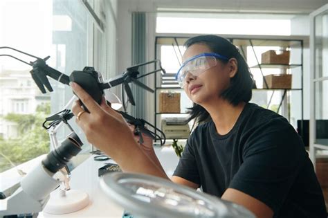 Premium Photo Woman Repairing Broken Drone In Workshop