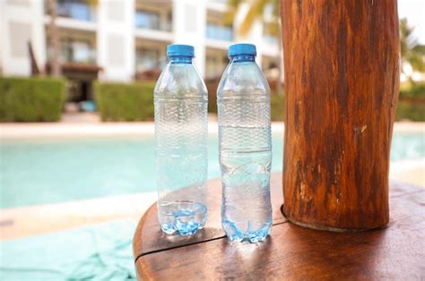 Premium Photo Two Empty Bottles Of Water Next To A Pool
