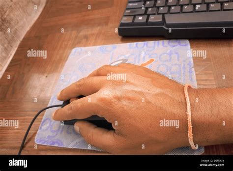 Image Of Female Hand Clicking Computer Mouse A Computer Keyboard Is Placed Nearby Stock Photo
