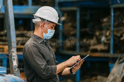 Engineering Man Wear Face Mask Using Tablet At Factory Heavy Industry
