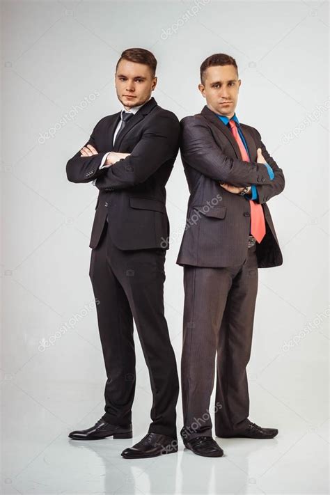 Two Men Standing Next To Each Other In Front Of A Cem