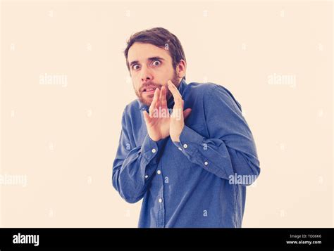 Portrait Of Young Man In Shock With Scared Face Paralysed With Fear And