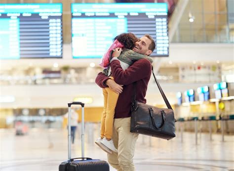 Premium Photo | Family father and child hug at airport travel and girl ...