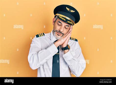 Handsome Middle Age Man With Grey Hair Wearing Airplane Pilot Uniform