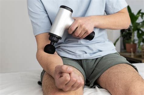 Free Photo Person Using Massage Gun Free Photo Person Using Massage Gun