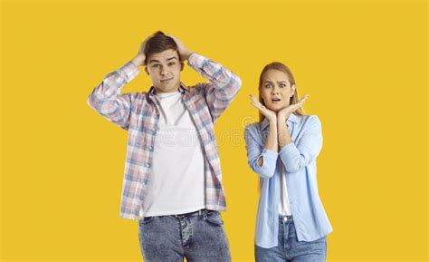 Portrait Of Young Man And Woman Looking At Something With Shocked Face