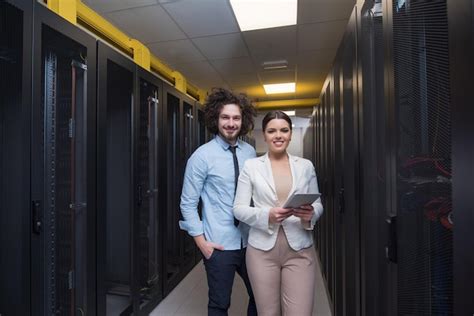 Premium Photo Young It Engineer Showing Working Data Center Server Room To Female Chief