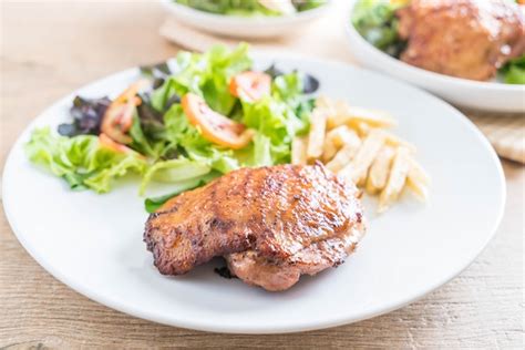 Premium Photo Grilled Chicken Steak With French Fries And Vegetable Salad