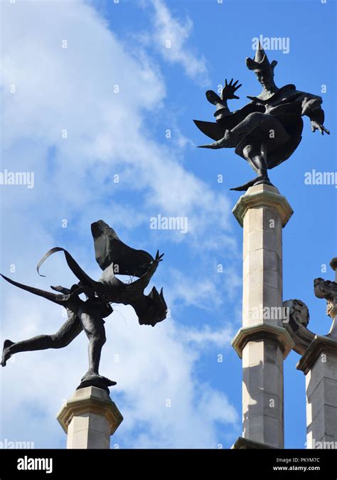 Facade Of An Old Historic Building With Statues Of Harlequins On The