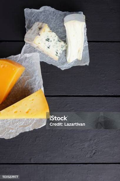 블랙 보드에 하드 옐로 치즈 카망트와 블루 치즈 다양 한 종류의 치즈를 양피지에 스위스 치즈와도 르 블루 어두운 배경 평면도 0명에 대한 스톡 사진 및 기타 이미지 Istock