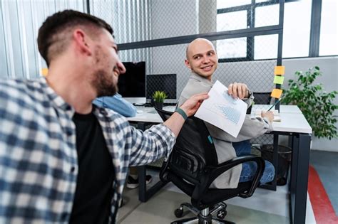 Premium Photo Businessman Passing Over Paper To His Colleague In Office