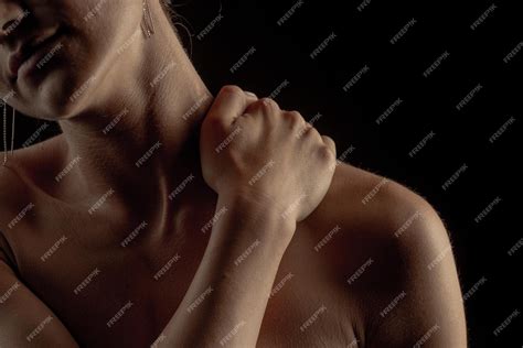 Premium Photo Female Back On A Dark Background Hands On The Neck With