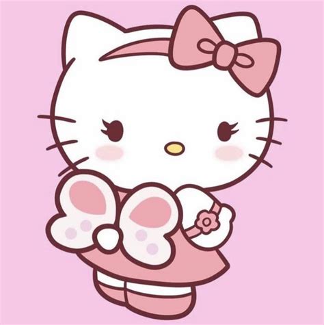 A Hello Kitty Holding A Teddy Bear In Her Arms And Wearing A Pink Dress
