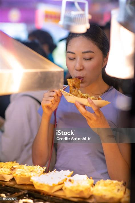타이페이 대만의 거리 야시장에서 타코 야 끼를 먹는 젊은 여자 야시장에 대한 스톡 사진 및 기타 이미지 야시장 타이베이