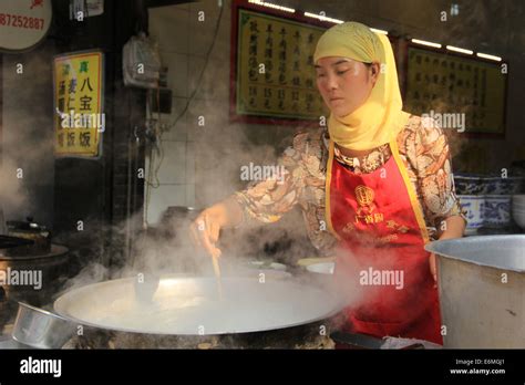 A Female Hui Muslim Sells Food In The Muslim Quarters Neighborhood Of