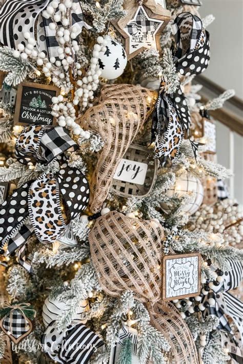 A Christmas Tree Decorated With Black And White Ribbon Ornaments And