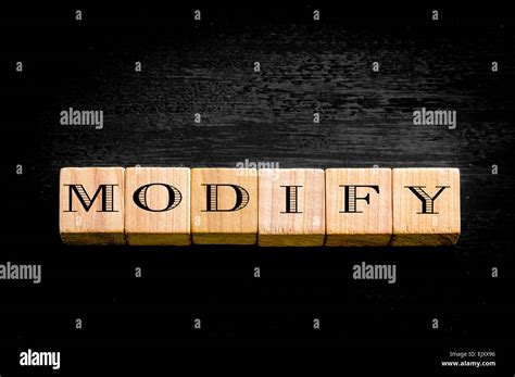 Word Modify Wooden Small Cubes With Letters Isolated On Black Background Concept Image Stock