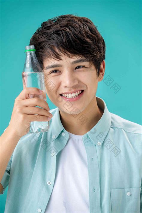 拿着汽水快乐的青年男人蓝色背景写实影相图片 包图网企业站