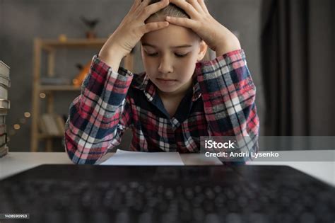 백인 아이 소녀는 집에서 노트북을 사용하여 웹캠보기를 사용하여 집에서 컴퓨터에서 온라인으로 공부하는 두통이 있습니다 온라인