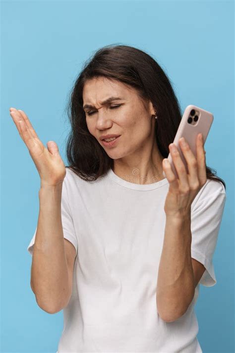 A Happy Joyful Woman Stands With A Phone In Her Hands Spreading Her