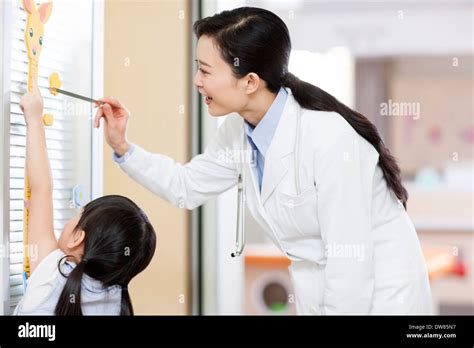 Doctor Measuring Girl S Height Stock Photo Alamy