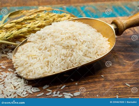Organic White Uncooked Rice and Dried Basmati Rice Plant Onwooden Table ...