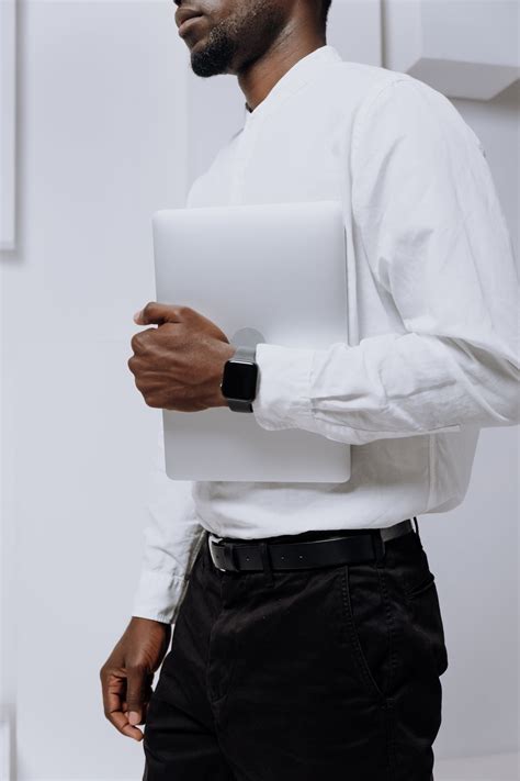 Man In White Dress Shirt And Black Pants Holding White Paper · Free