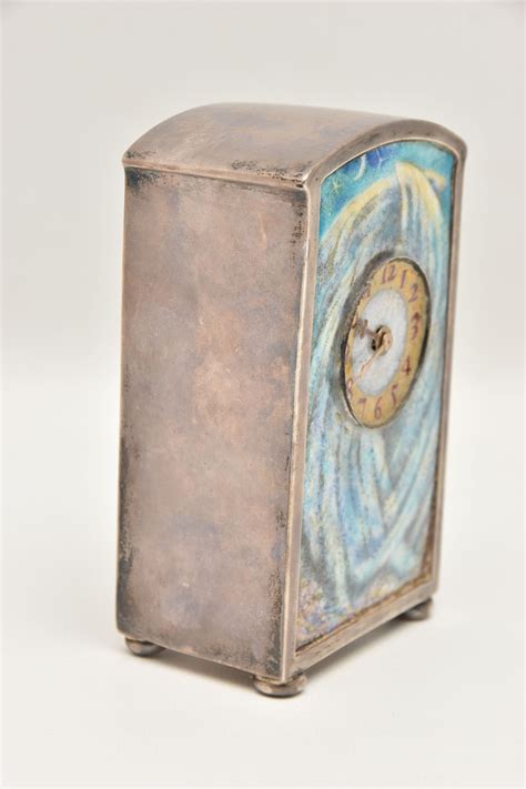 A Liberty And Co Silver And Enamel Mantle Clock Featuring A Yellow And