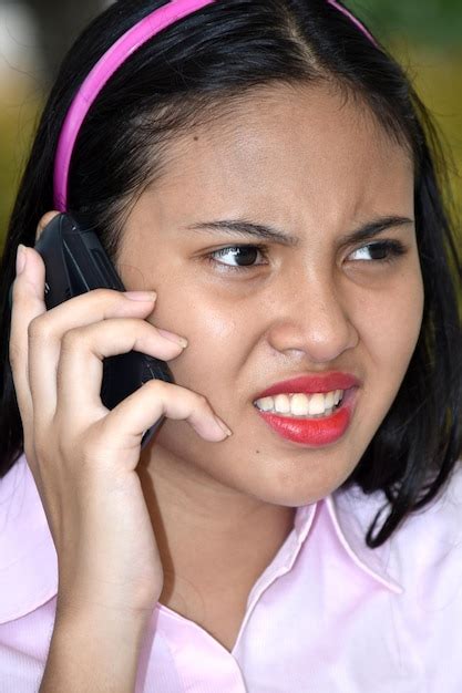 Premium Photo Close Up Of Girl Making Face While Talking On Phone