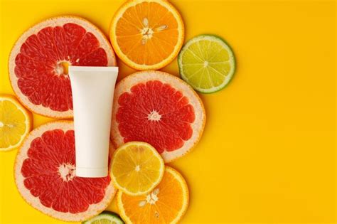 Premium Photo Cosmetic Container On Yellow Background With Cut Citrus